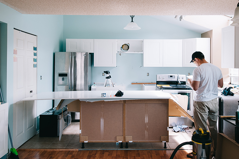 man renovating kitchen - Best Apartment Renovations NYC